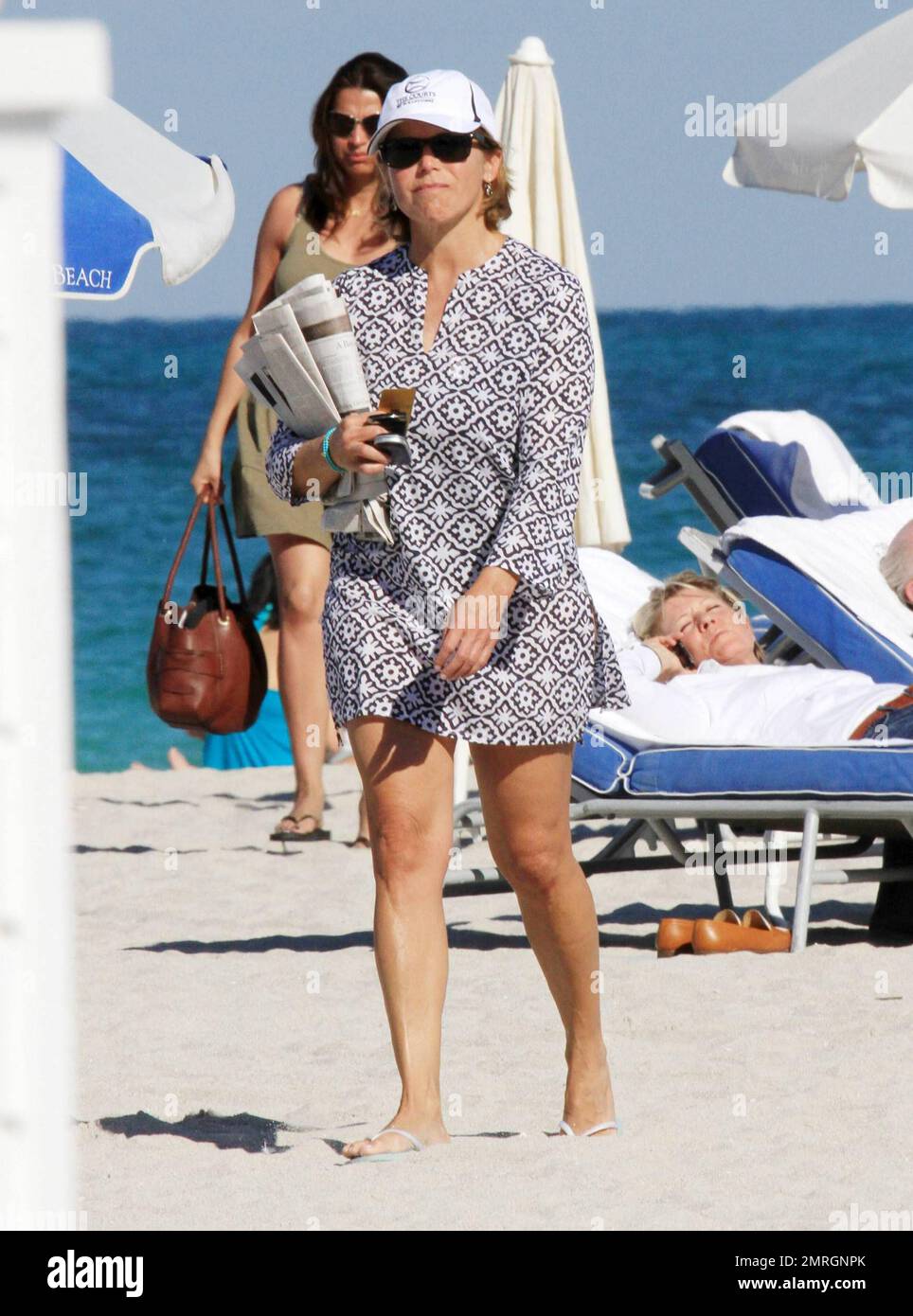 Cbs News Anchor Katie Couric Covers Up With A Patterned Top And Hat