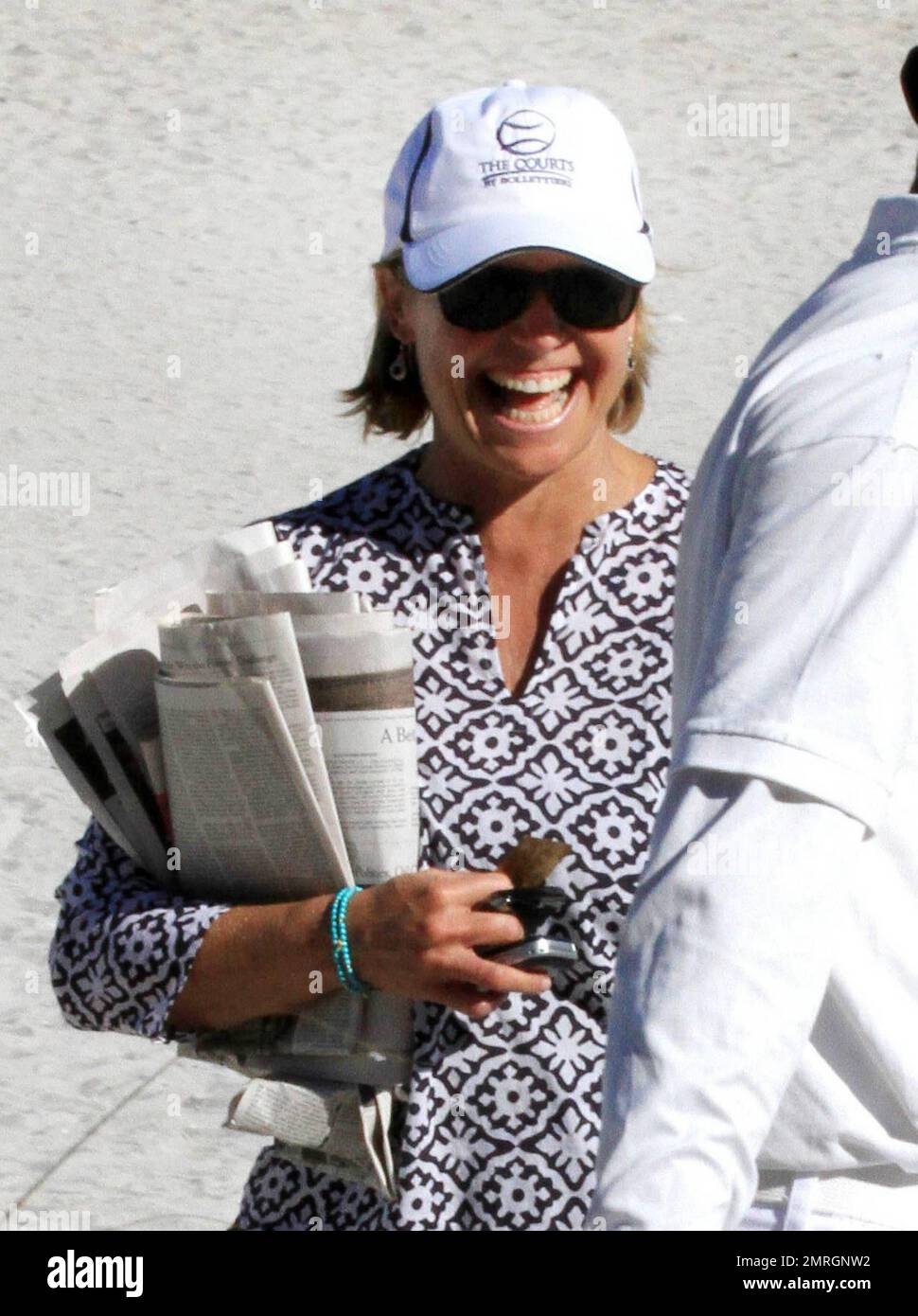 CBS news anchor Katie Couric covers up with a patterned top and hat ...