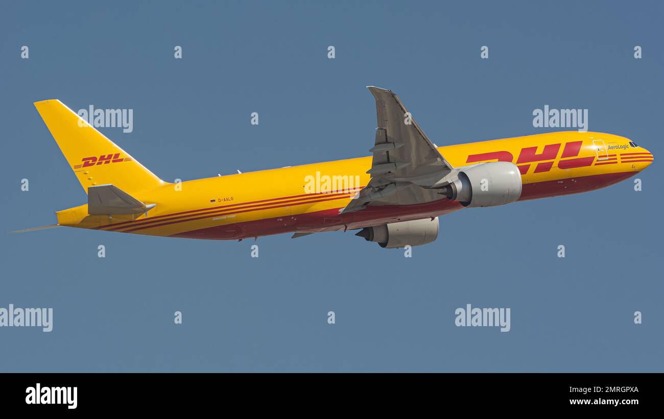 A closeup of the Boeing 767 DHL in a flight on a blue sky background ...