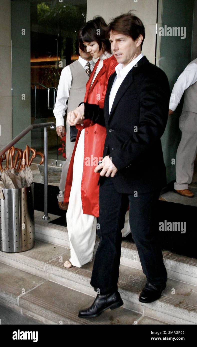 Tom Cruise and Katie Holmes make their way out of the Raffles L ...