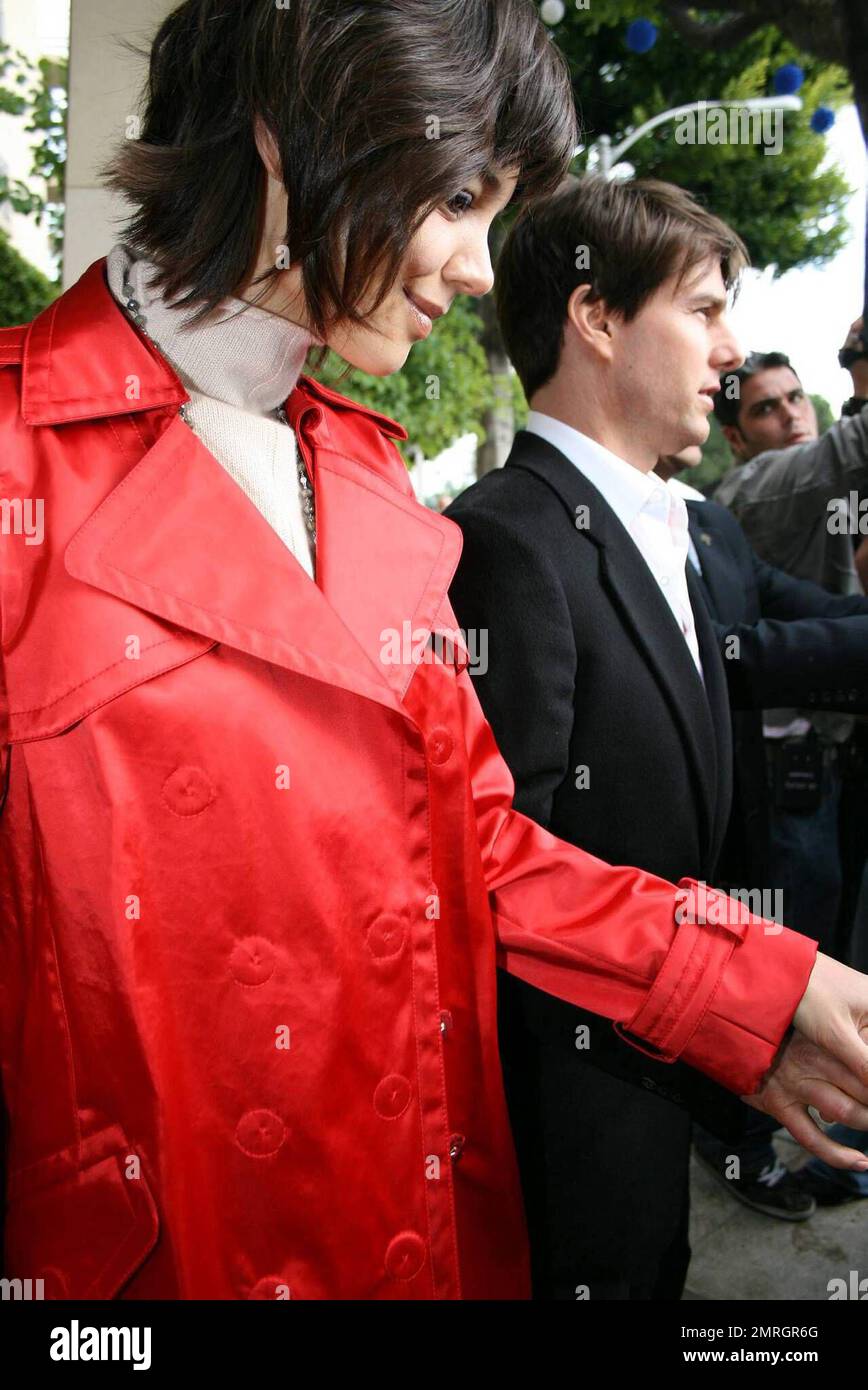 Tom Cruise and Katie Holmes make their way out of the Raffles L ...