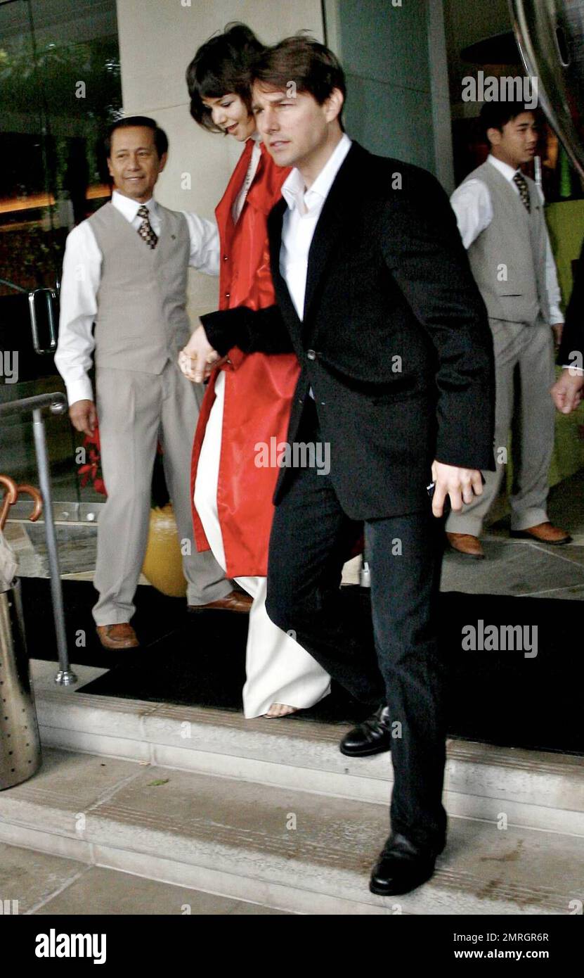 Tom Cruise and Katie Holmes make their way out of the Raffles L ...