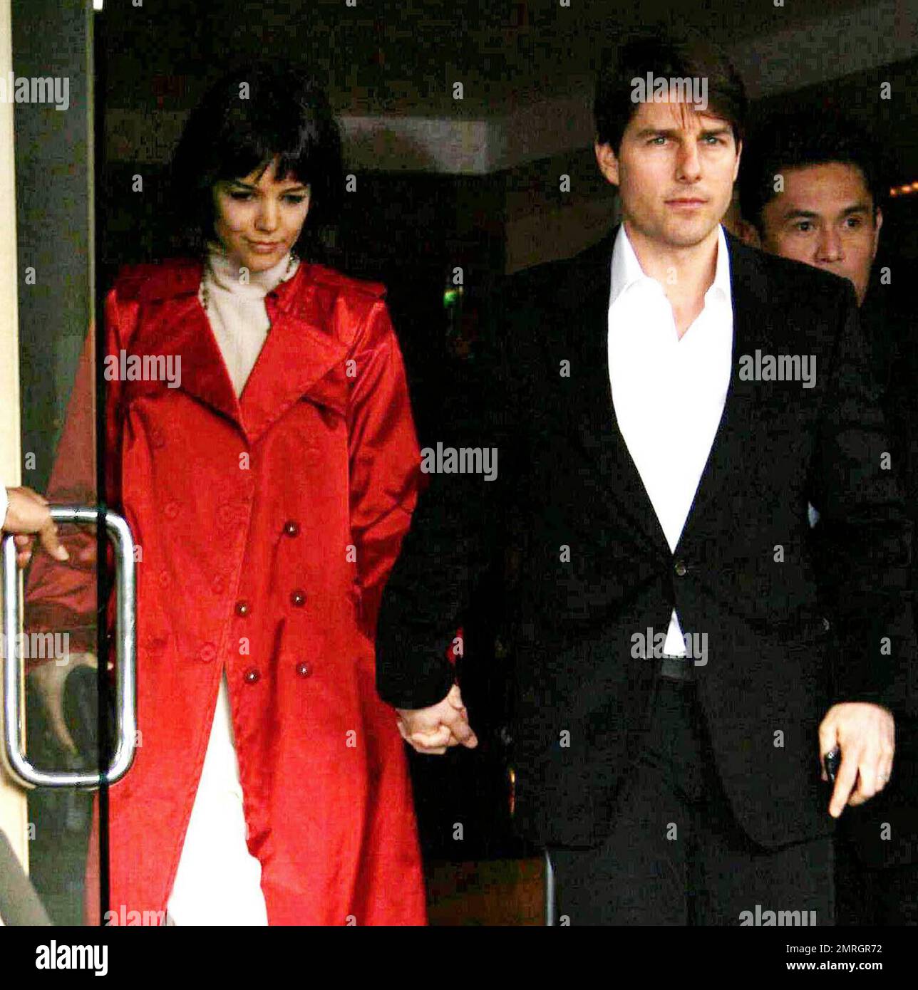 Tom Cruise and Katie Holmes make their way out of the Raffles L ...
