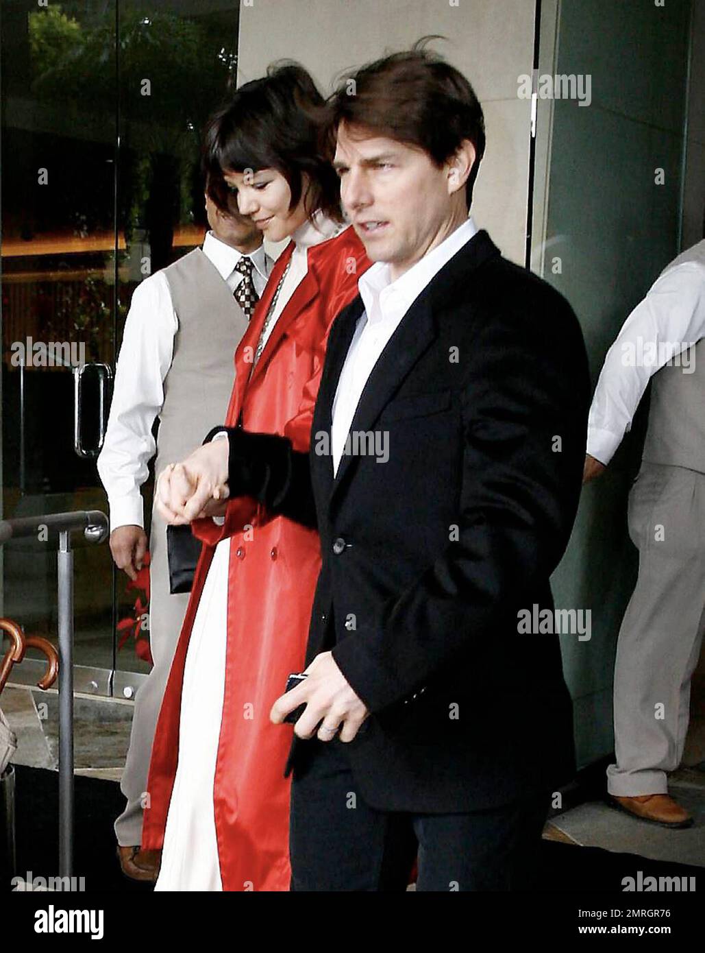 Tom Cruise and Katie Holmes make their way out of the Raffles L ...