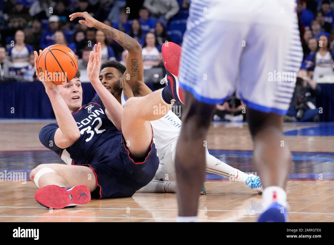 Connecticut's Donovan Clingan and DePaul's K.T. Raimey battle for a ...