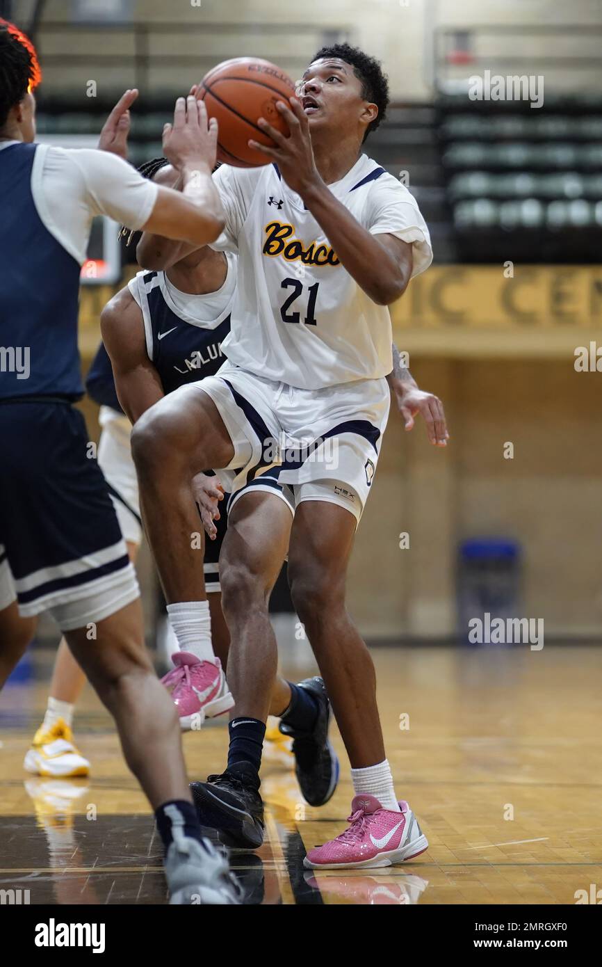 A portrait of basketball players playing in the court during a ...