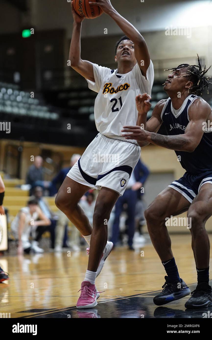 A portrait of basketball players playing in the court during a ...