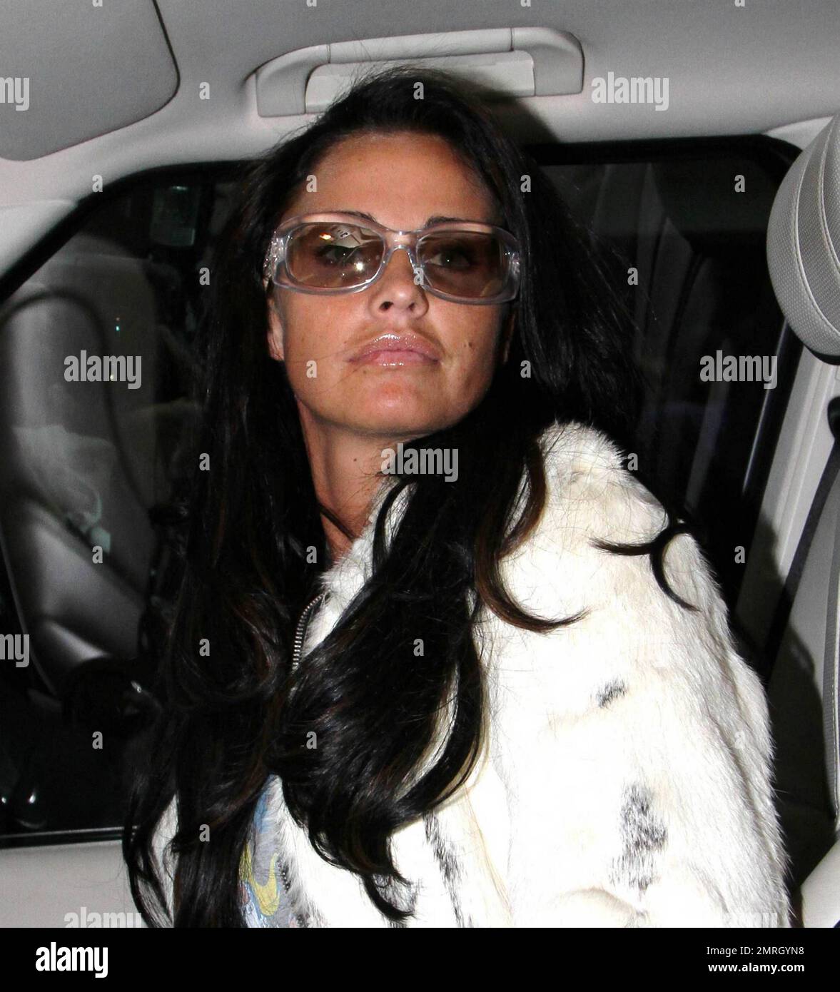 Katie Price leaves the Mayfair Hotel in her white Range Rover Sport and matching white fur ...