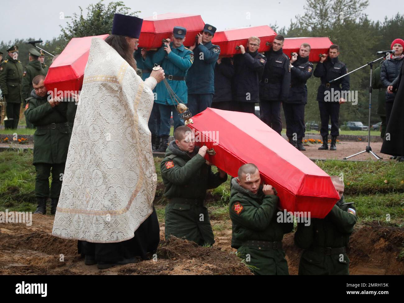 An Orthodox priest conducts a burial ceremony of Soviet soldiers killed ...