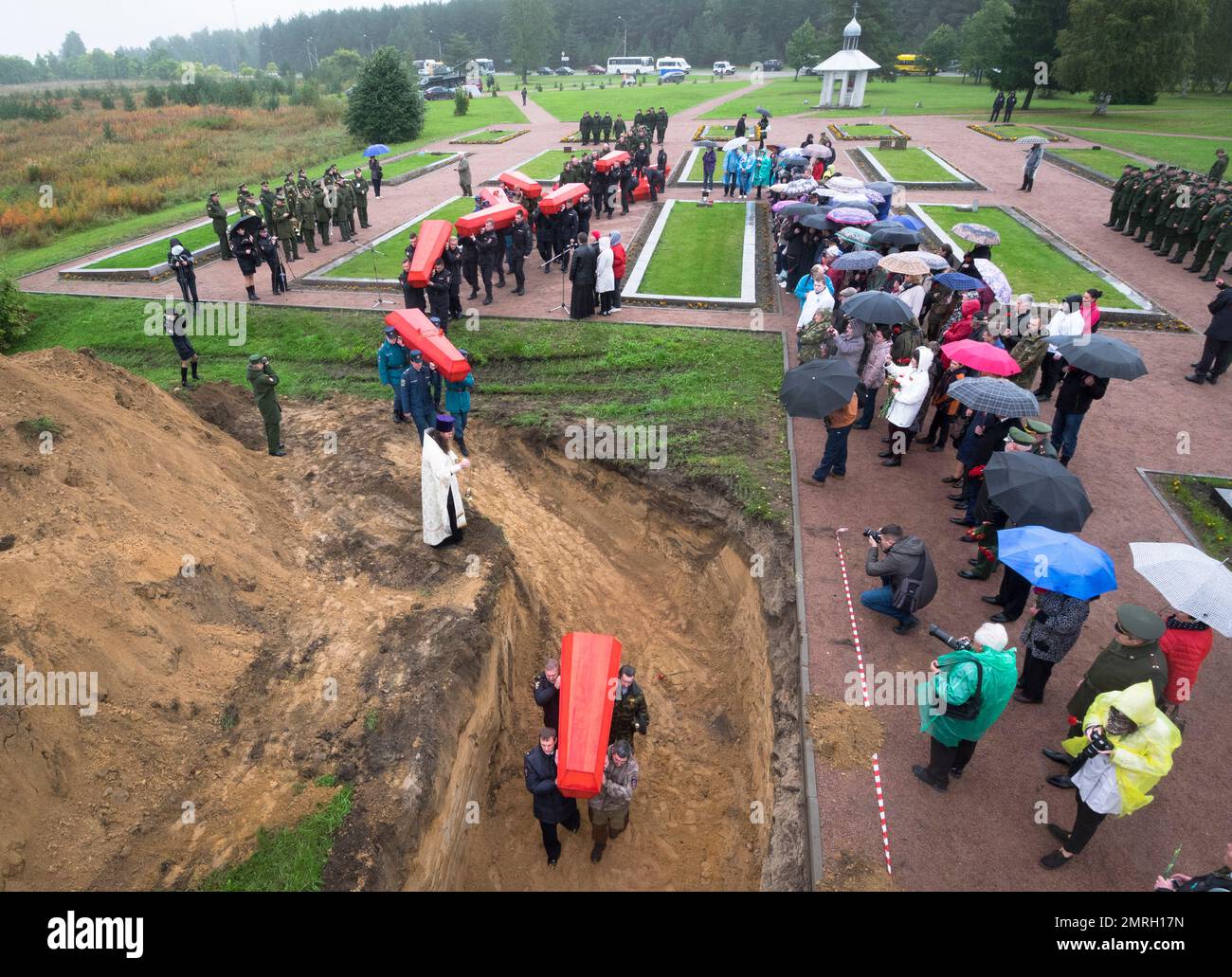 An Orthodox priest conducts a burial ceremony of Soviet soldiers killed ...
