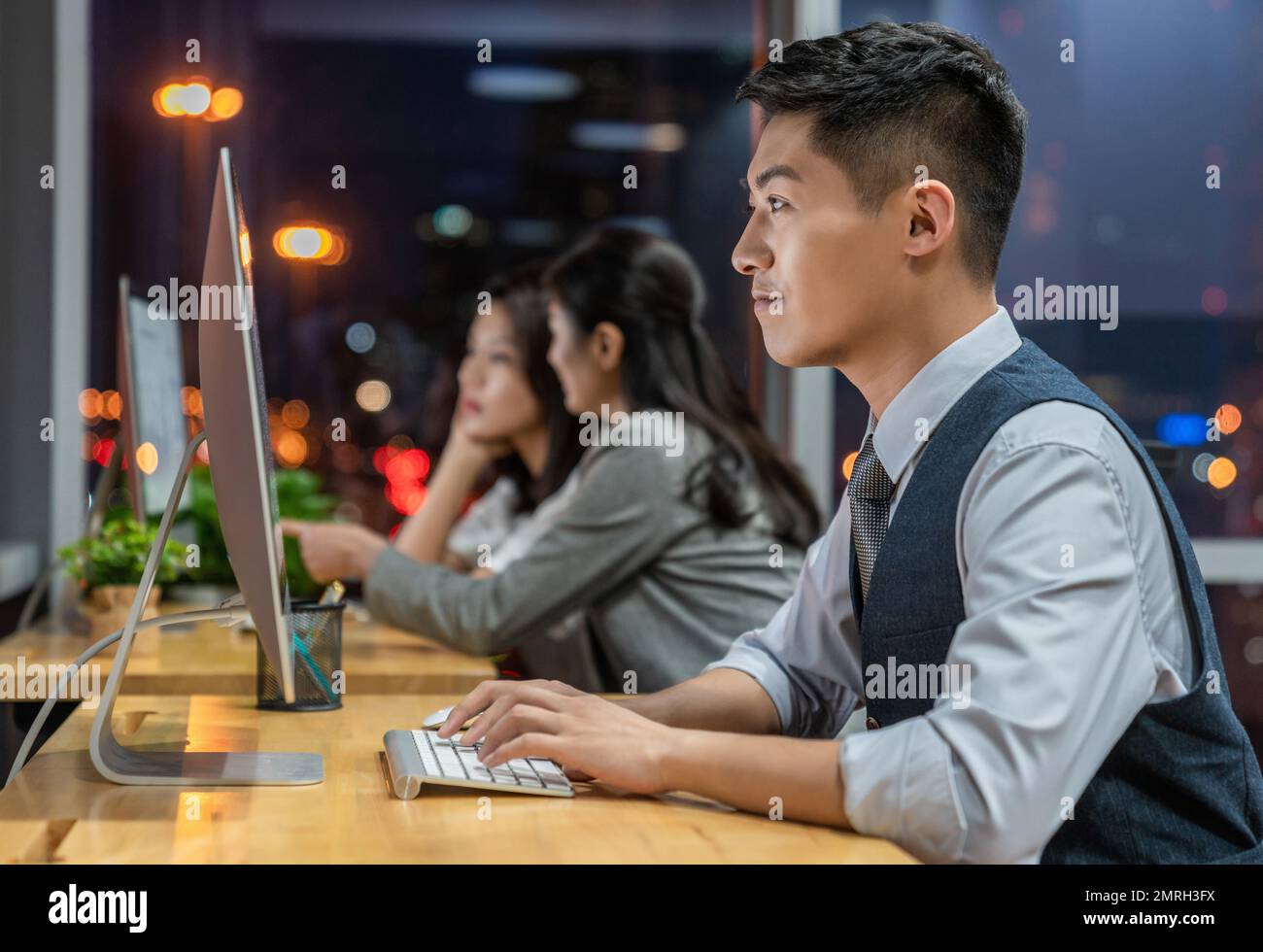 Young business people in work overtime Stock Photo - Alamy