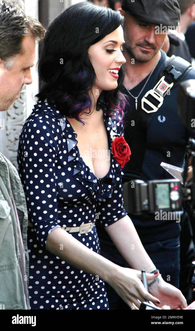 Katy Perry smiles as she greets fans and signs autographs for her many ...