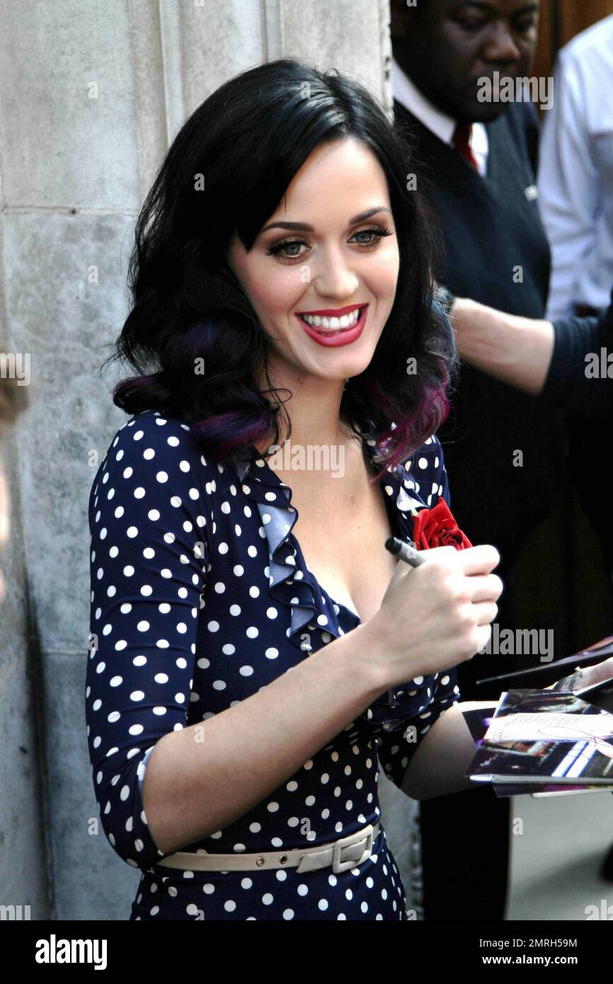 Katy Perry smiles as she greets fans and signs autographs for her many ...