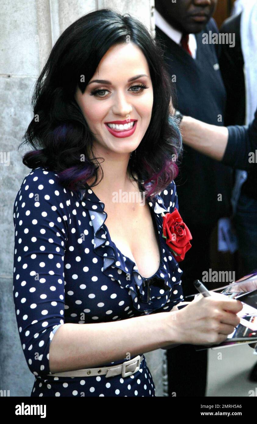 Katy Perry smiles as she greets fans and signs autographs for her many ...