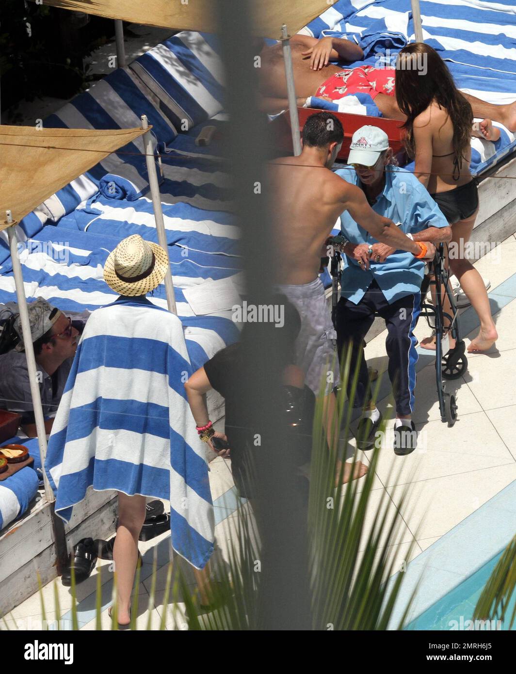 Katy Perry shows off her figure in a black string bikini during a break ...