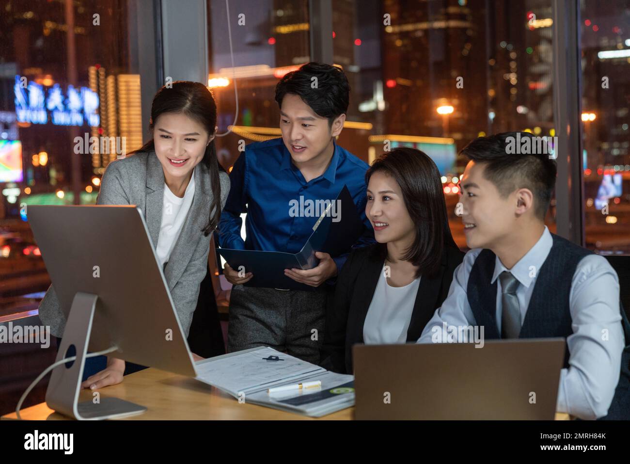 Young business people in work overtime Stock Photo - Alamy