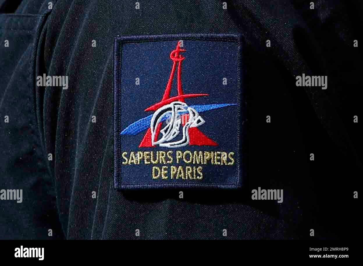 The logo of Paris Fire Brigade is pictured as Firemen stand at ...