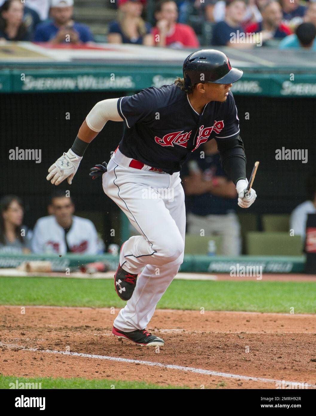 Cleveland Indians' Erik Gonzalez runs to first base while holding a ...