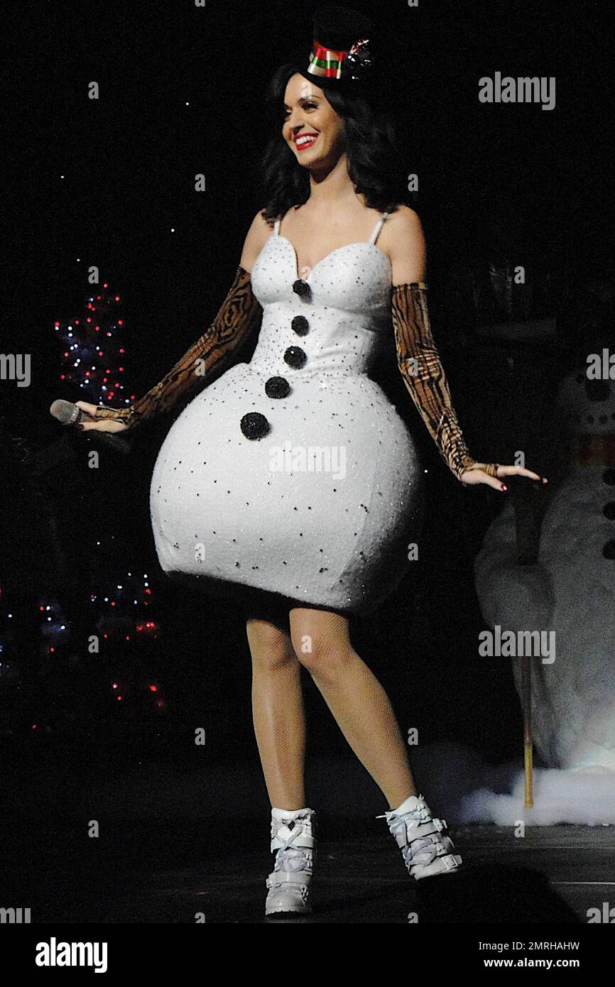 Pop singer Katy Perry emerges from a giant Christmas present and ...