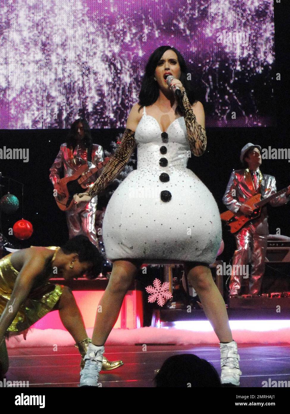 Pop singer Katy Perry emerges from a giant Christmas present and ...