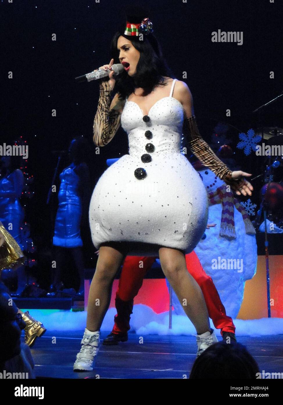 Pop singer Katy Perry emerges from a giant Christmas present and ...