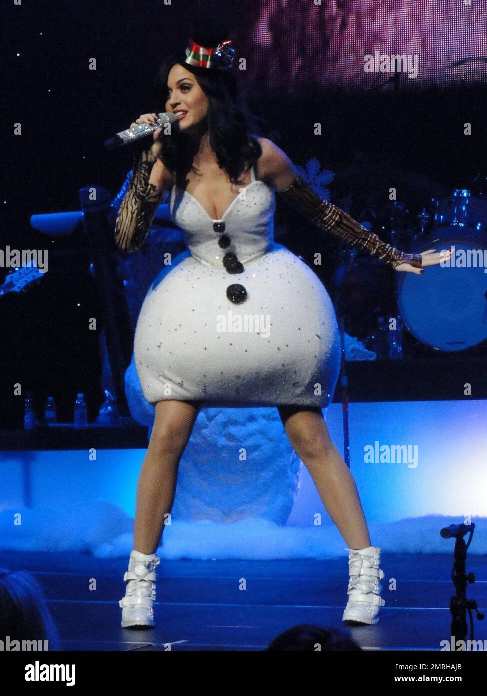 Pop singer Katy Perry emerges from a giant Christmas present and ...