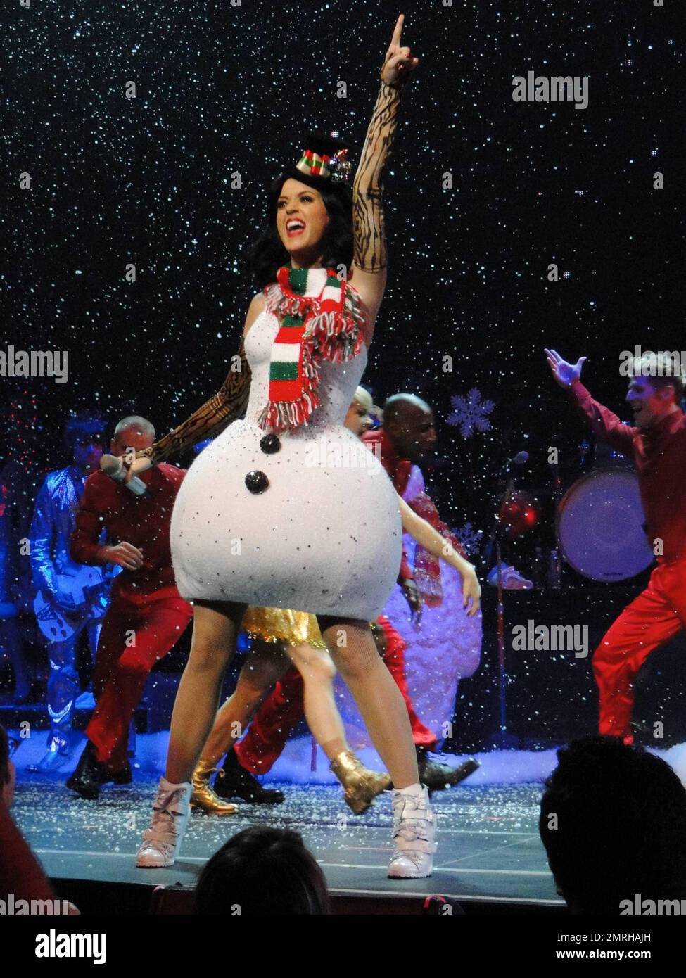 Pop singer Katy Perry emerges from a giant Christmas present and ...