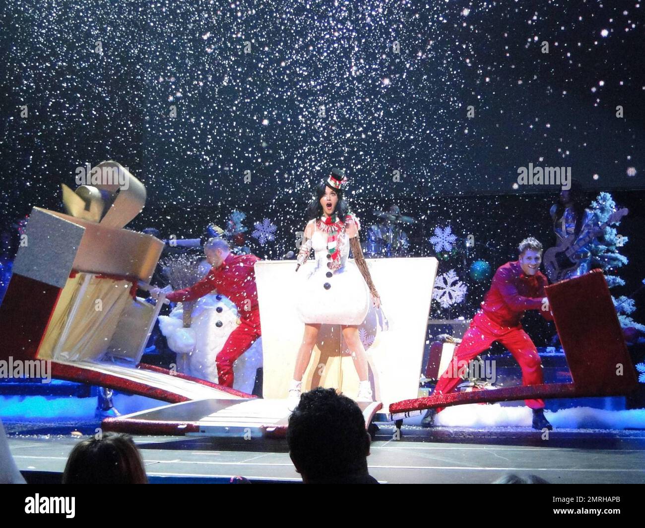 Pop singer Katy Perry emerges from a giant Christmas present and ...