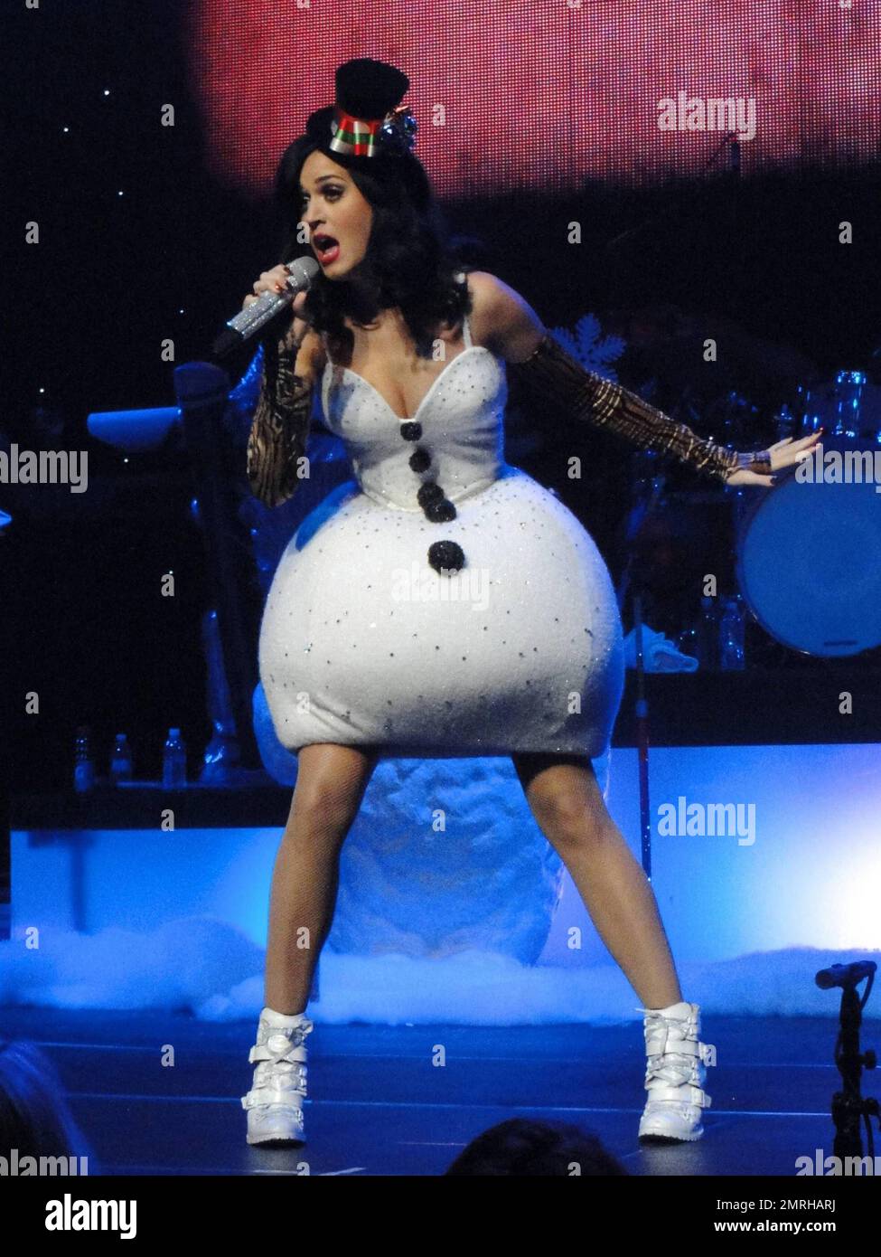 Pop singer Katy Perry emerges from a giant Christmas present and ...