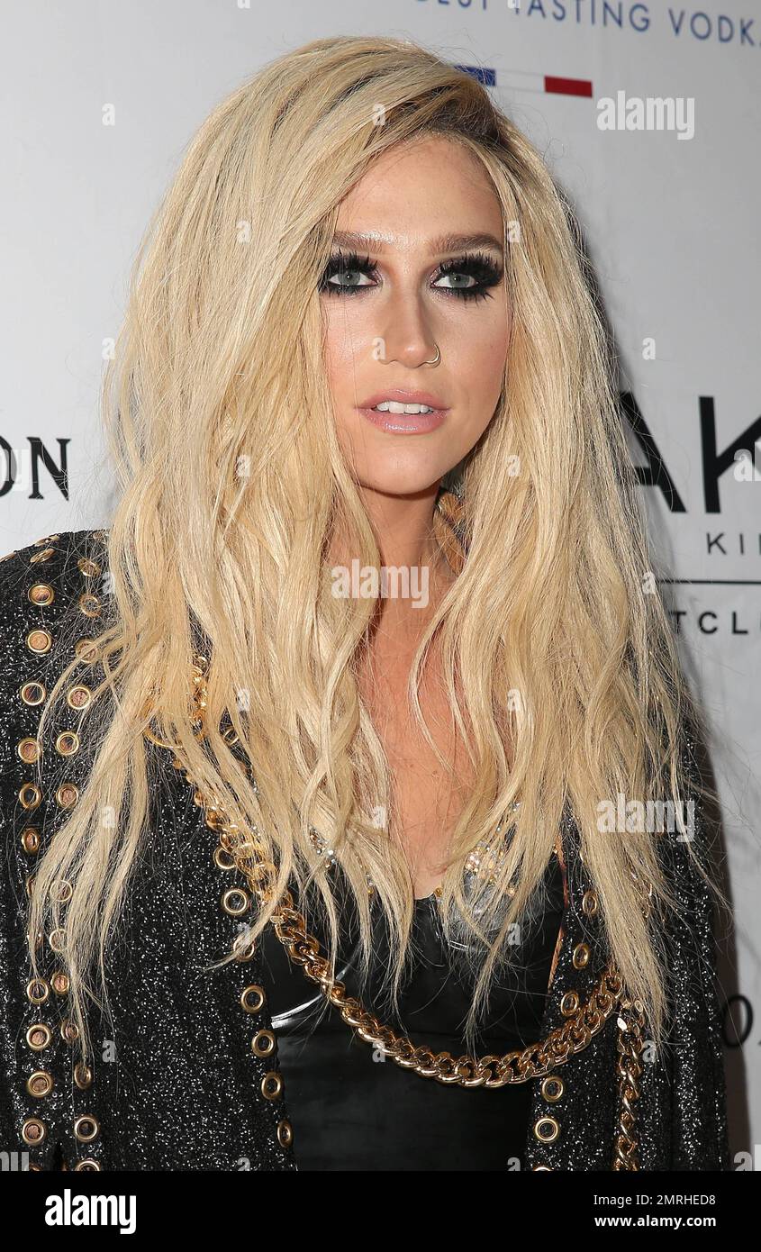 Wearing a black leather leotard under a black & gold shinny cape with ...