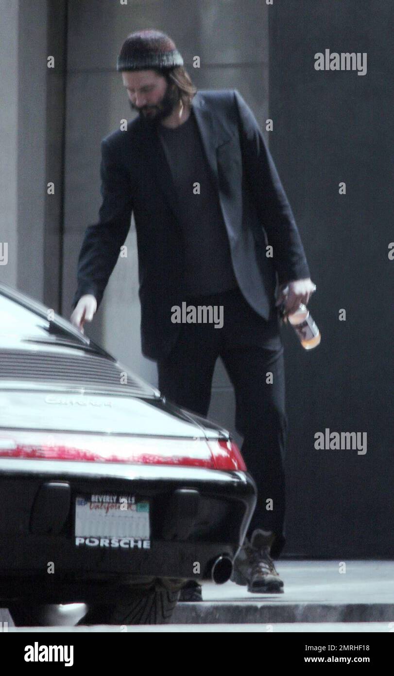 Exclusive!! A sad looking Keanu Reeves tenderly opens the car door for ...