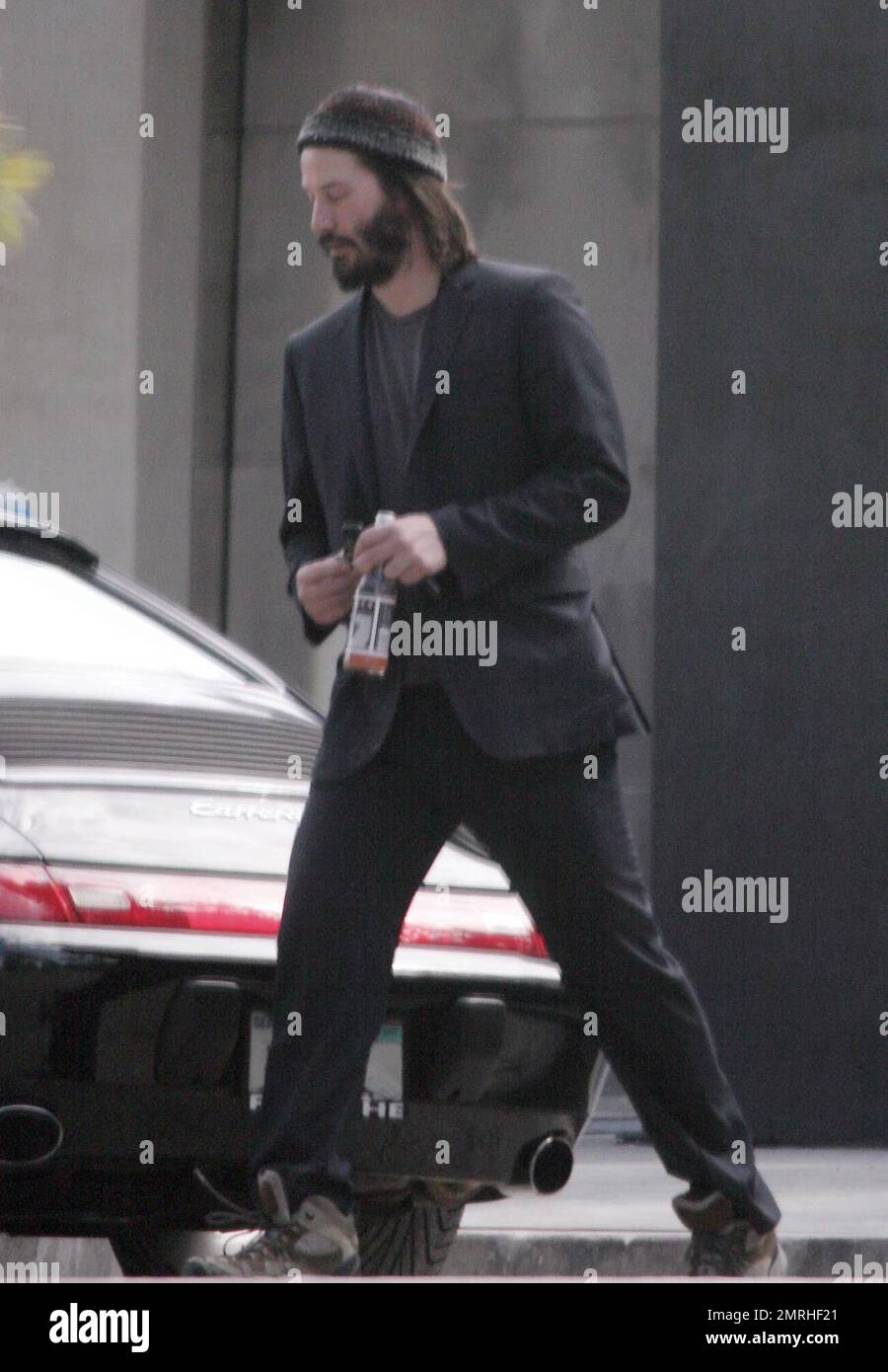 Exclusive!! A sad looking Keanu Reeves tenderly opens the car door for ...