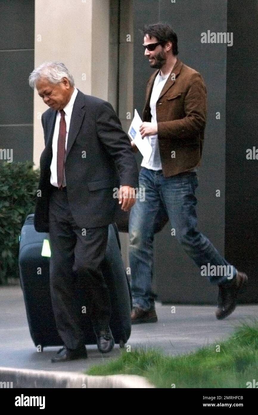 EXCLUSIVE!! Keanu Reeves is met by a driver as he leaves on a trip. The ...