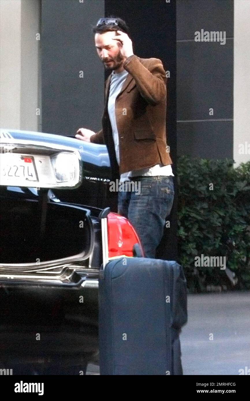 EXCLUSIVE!! Keanu Reeves is met by a driver as he leaves on a trip. The ...