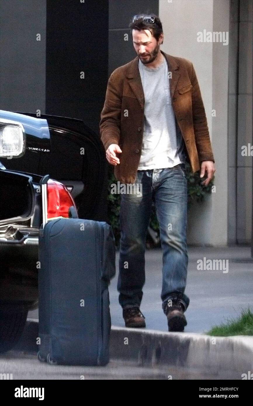 EXCLUSIVE!! Keanu Reeves is met by a driver as he leaves on a trip. The ...