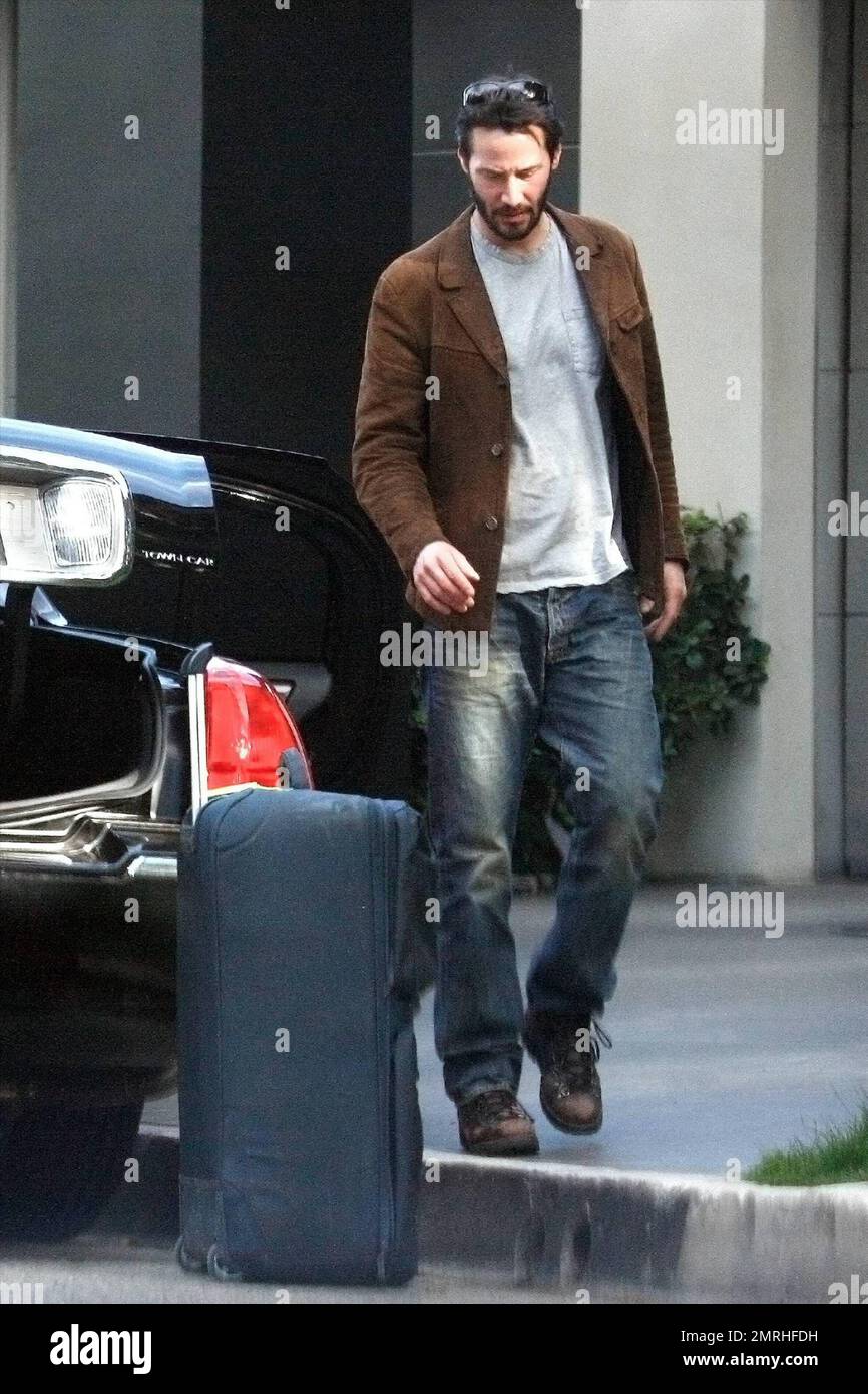 EXCLUSIVE!! Keanu Reeves is met by a driver as he leaves on a trip. The ...