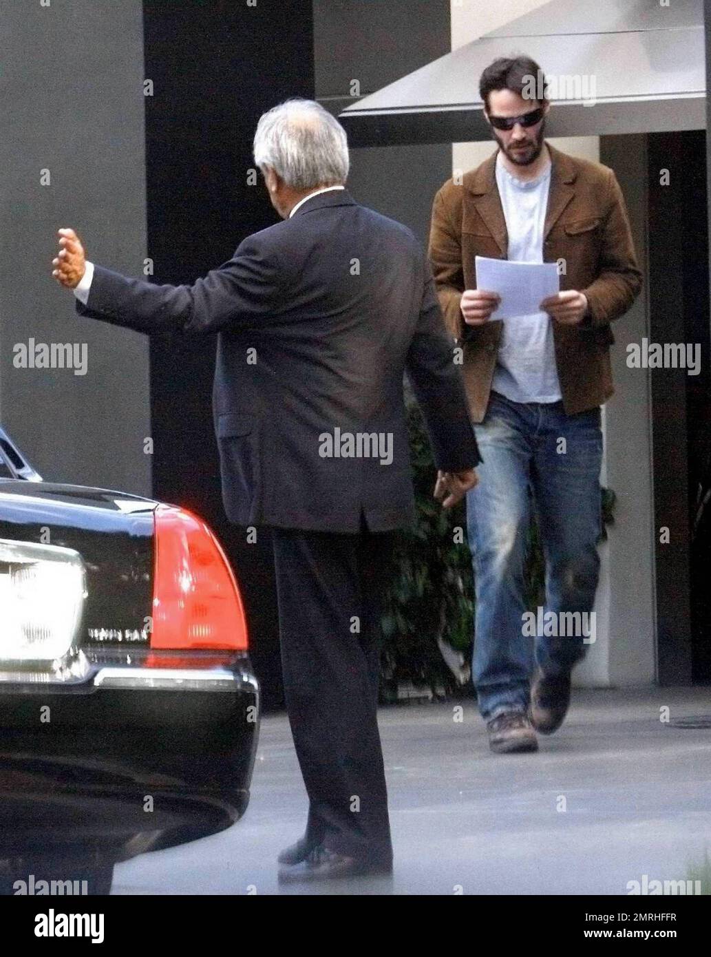 EXCLUSIVE!! Keanu Reeves is met by a driver as he leaves on a trip. The ...