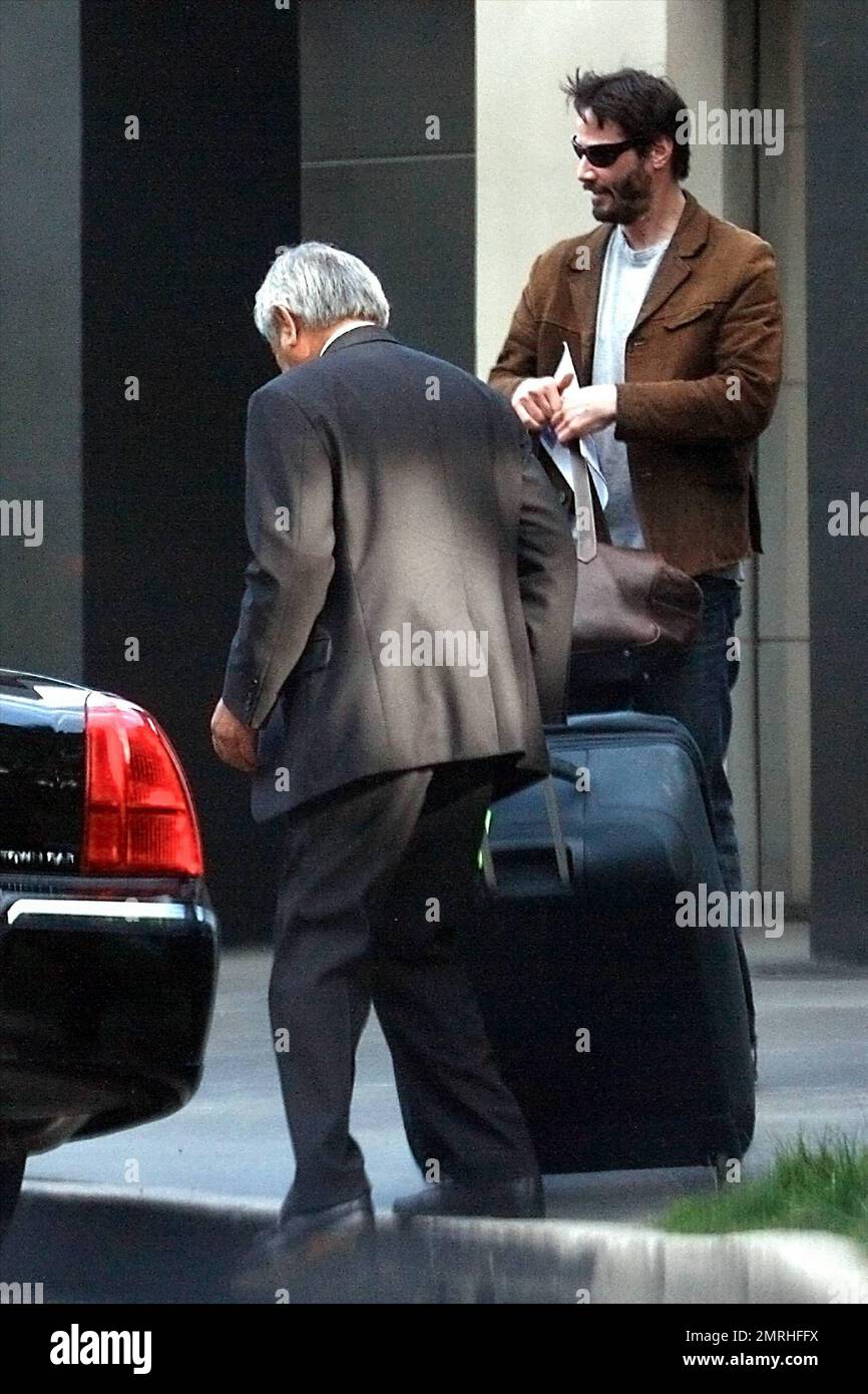 EXCLUSIVE!! Keanu Reeves is met by a driver as he leaves on a trip. The ...