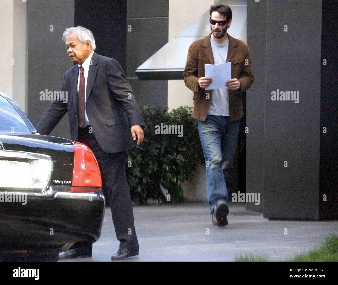 EXCLUSIVE!! Keanu Reeves is met by a driver as he leaves on a trip. The ...
