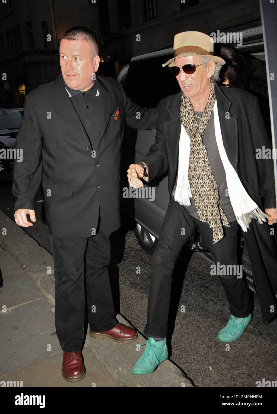 Rocker Keith Richards, wearing an outfit punctuated by bright green ...