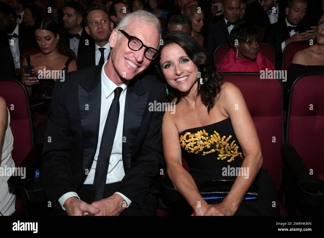 Brad Hall, left, and Julia Louis-Dreyfus pose in the audience at the ...