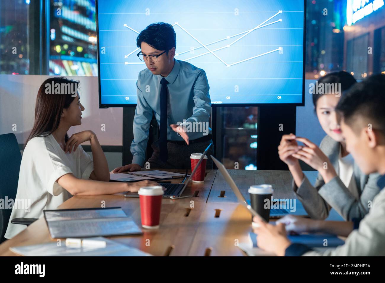 Young business people in work overtime Stock Photo - Alamy