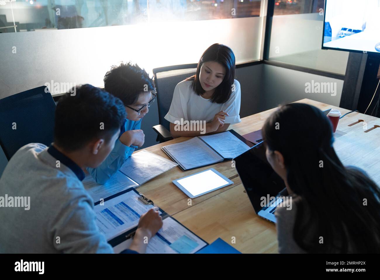 Young business people in work overtime Stock Photo - Alamy