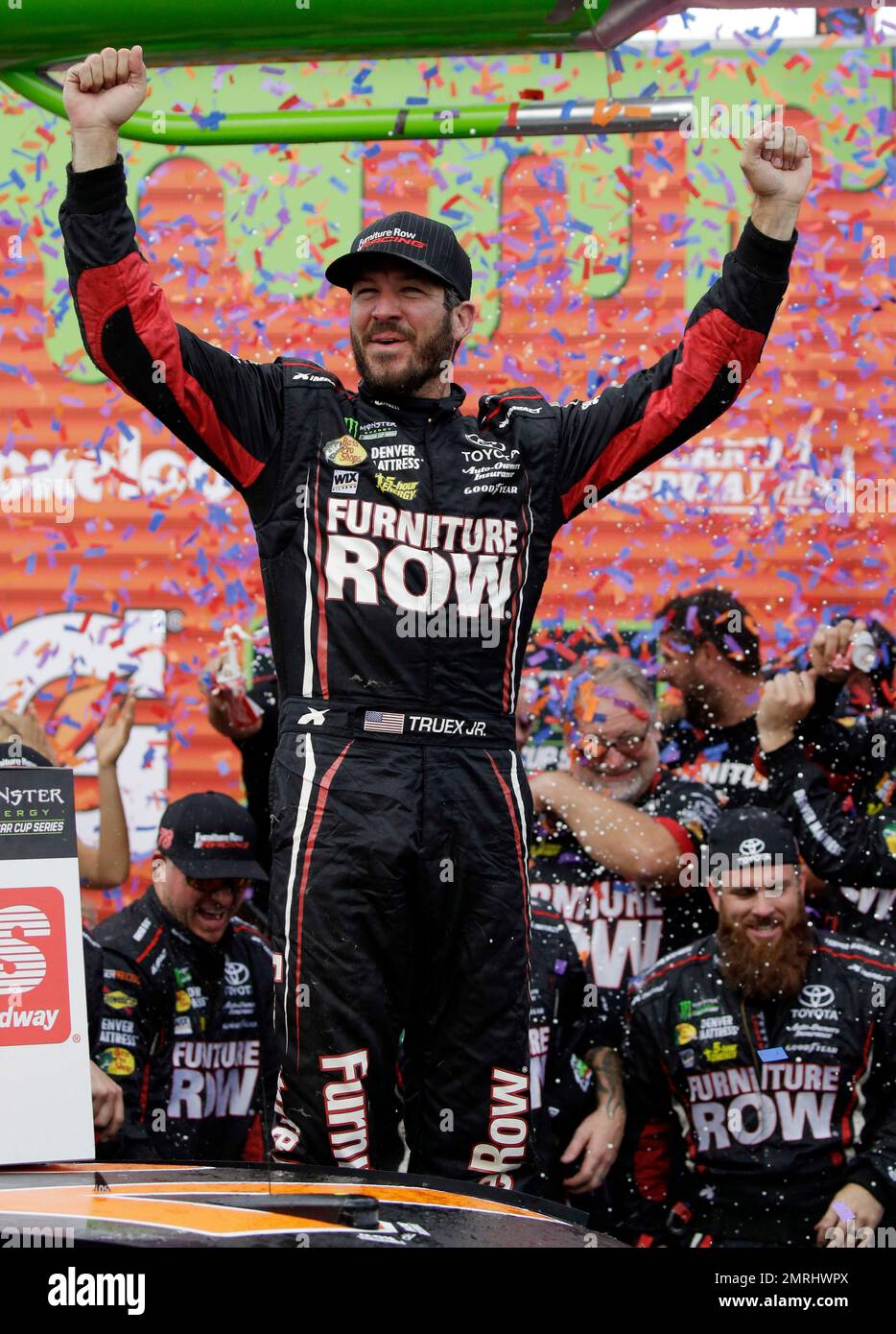 Martin Truex Jr. celebrates with his crew in Victory Lane after winning ...