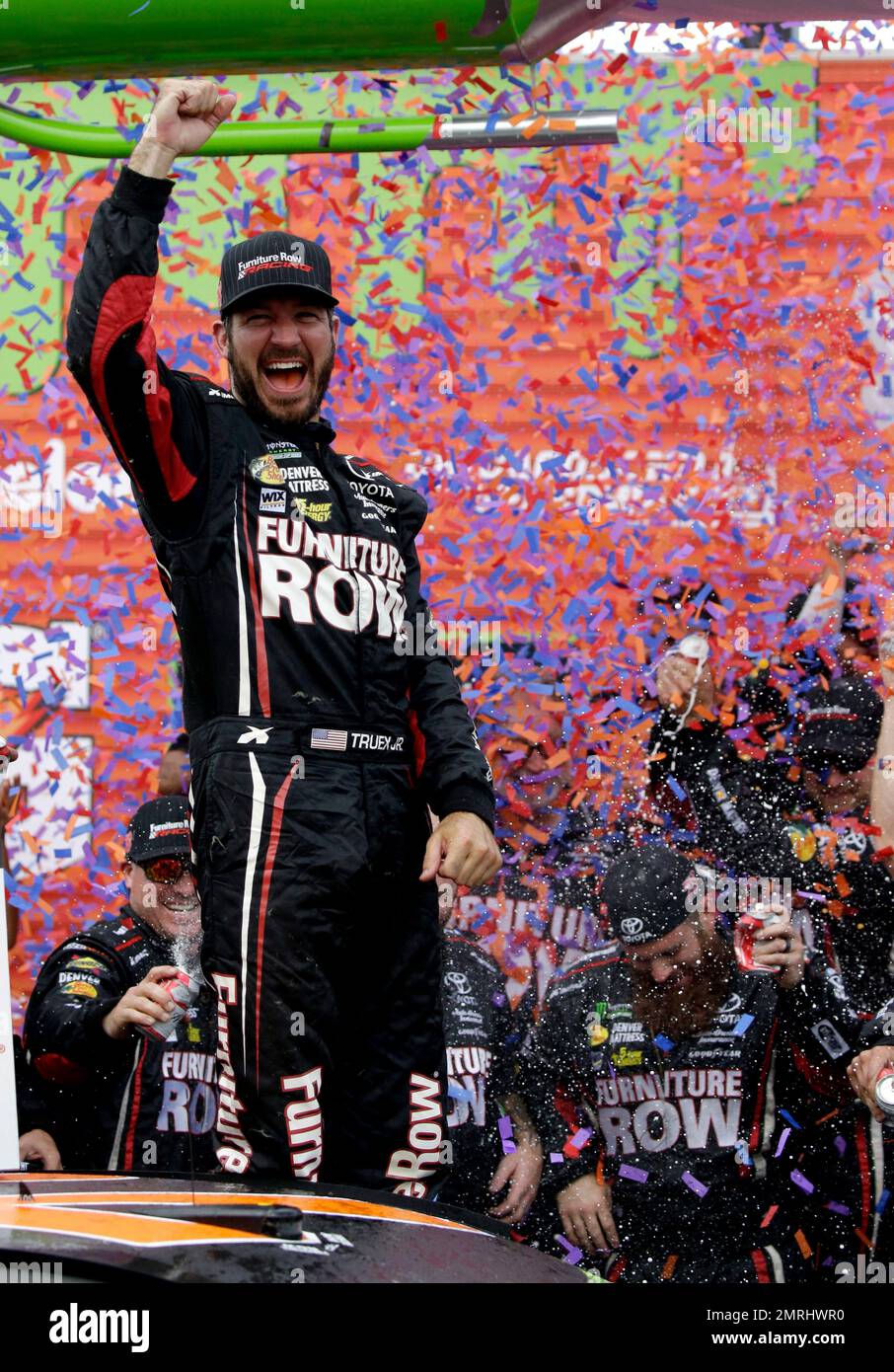 Martin Truex Jr. celebrates with his crew in Victory Lane after winning ...
