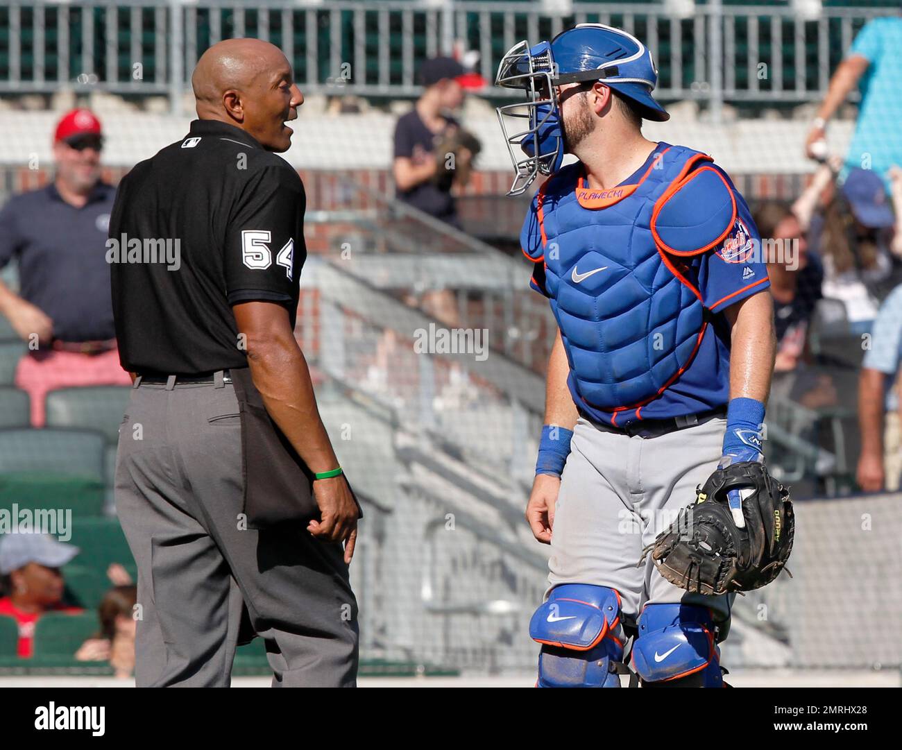 New York Mets' Kevin Plawecki (R) talks with home plate umpire C.B ...