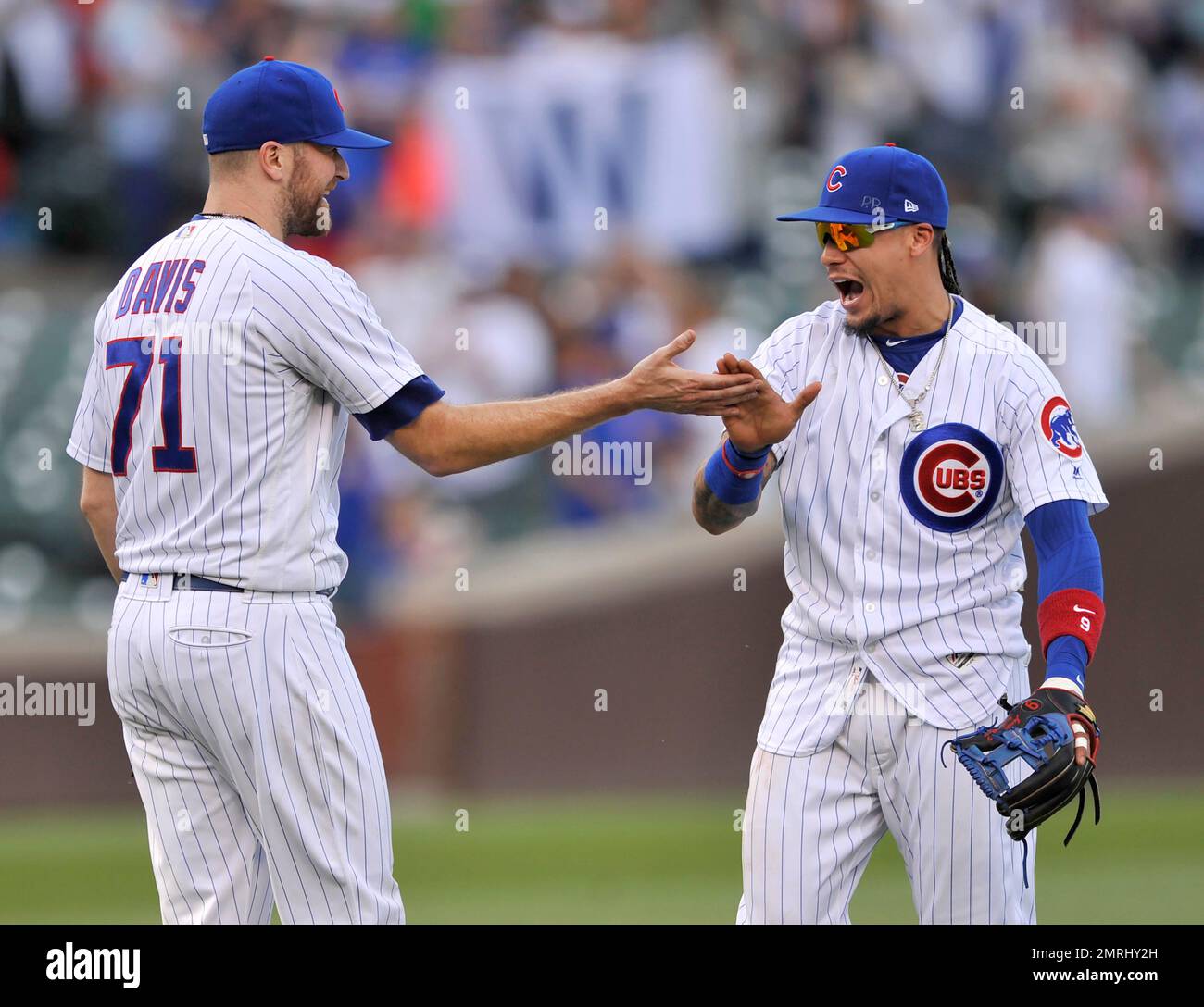 Chicago Cubs closing pitcher Wade Davis (71) celebrates with teammate ...