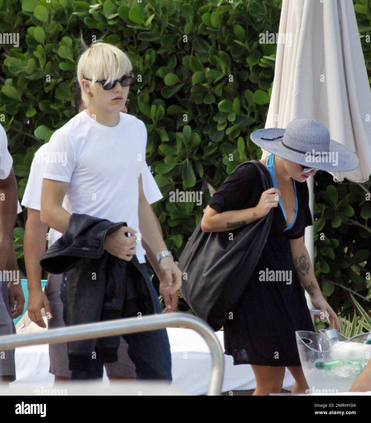 Kelly Osbourne chills out in a cabana poolside with fiance Luke Worrall ...