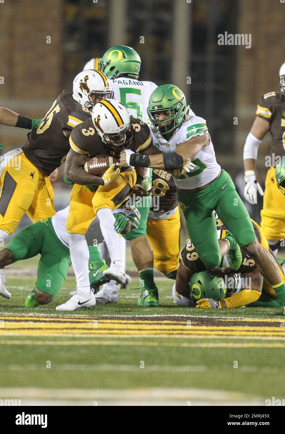 Wyoming running back Milo Hall (3) is tackled by Oregon inside ...