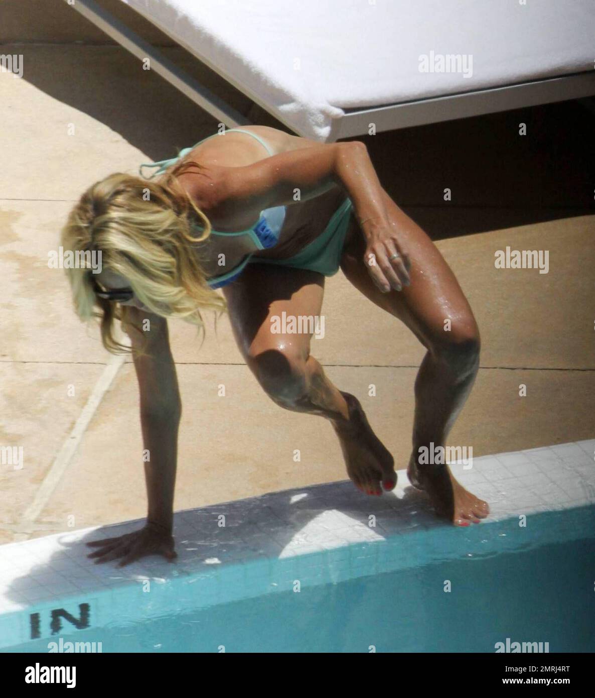 Exclusive!! Kelly Ripa takes a refreshing dip in the pool after filming Live With Regis And ...